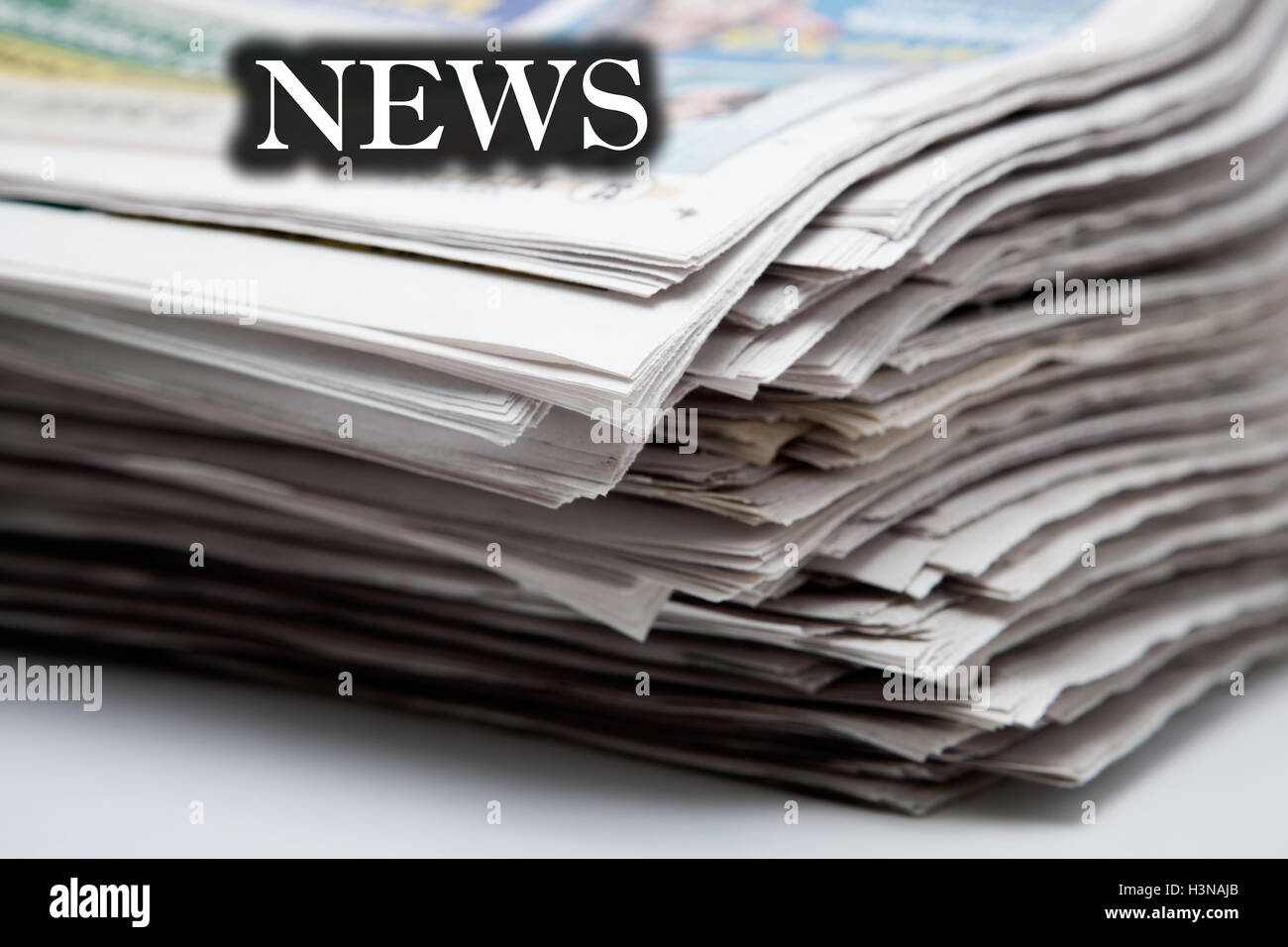 stack of newspapers on a white background Stock Photo - Alamy