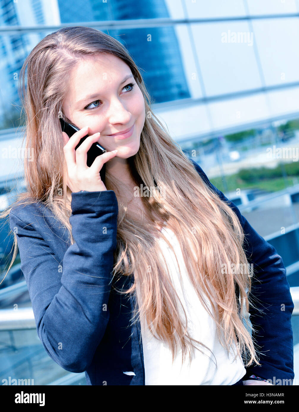 Junior executive dynamic phoning outside of her office Stock Photo - Alamy