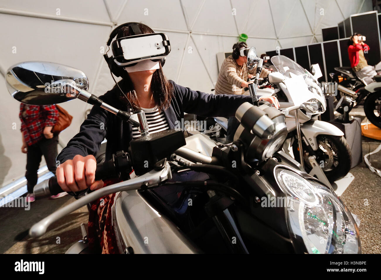 Tokyo, Japan. 10th October, 2016. Visitors enjoy virtual reality ...