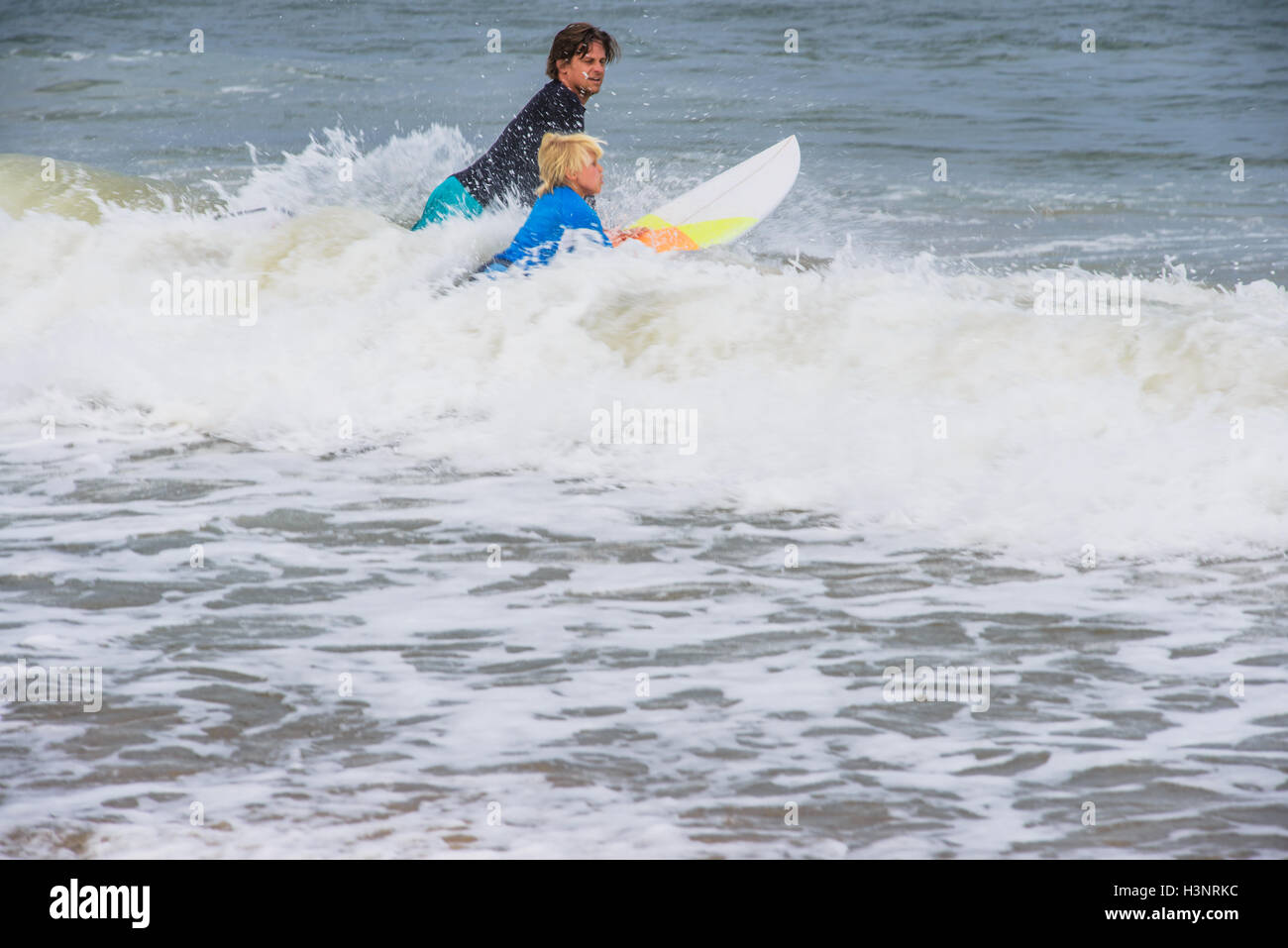 Father and son in sea with surfboards, getting ready to surf Stock ...