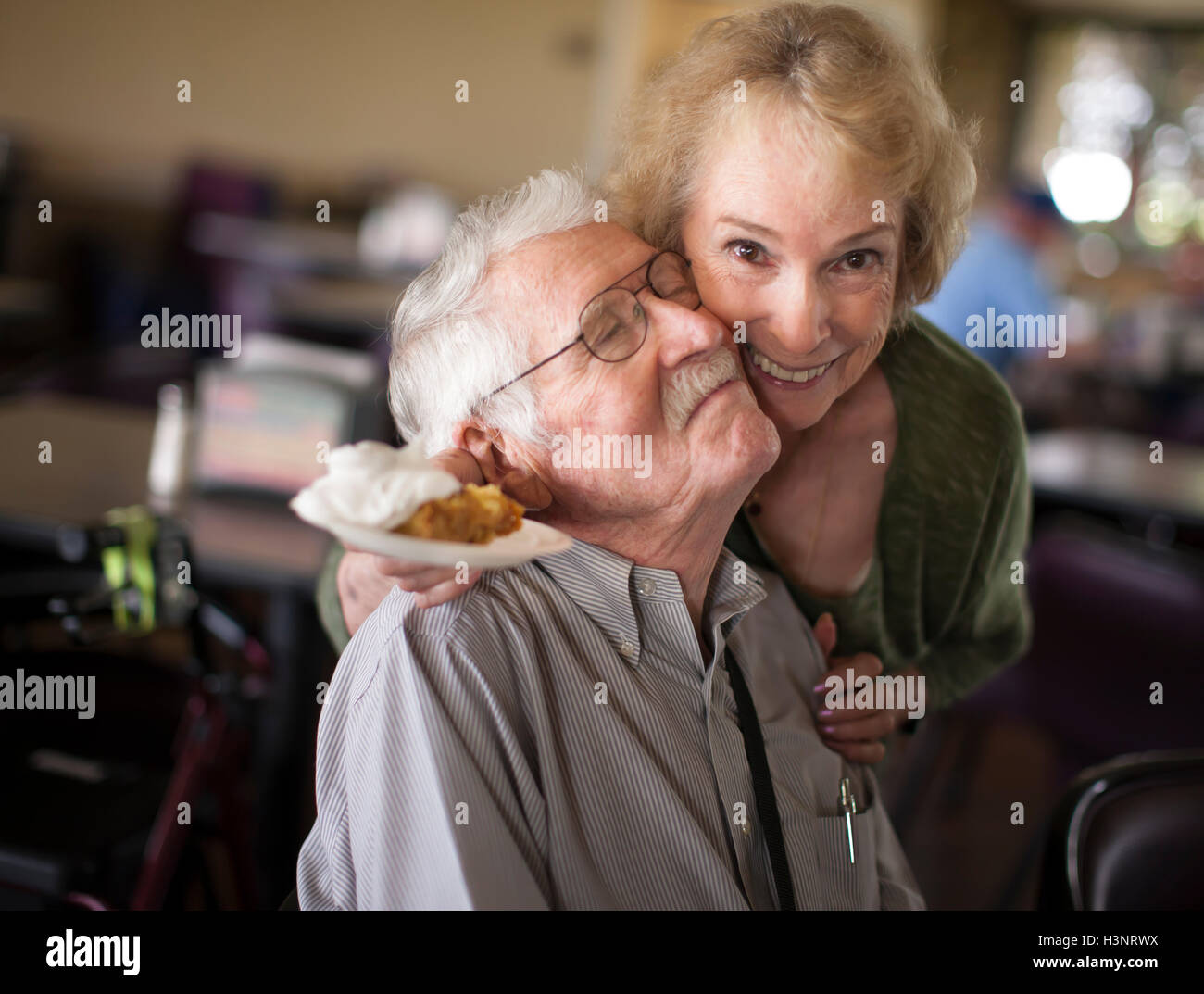 Senior woman hugging senior man, smiling Stock Photo - Alamy