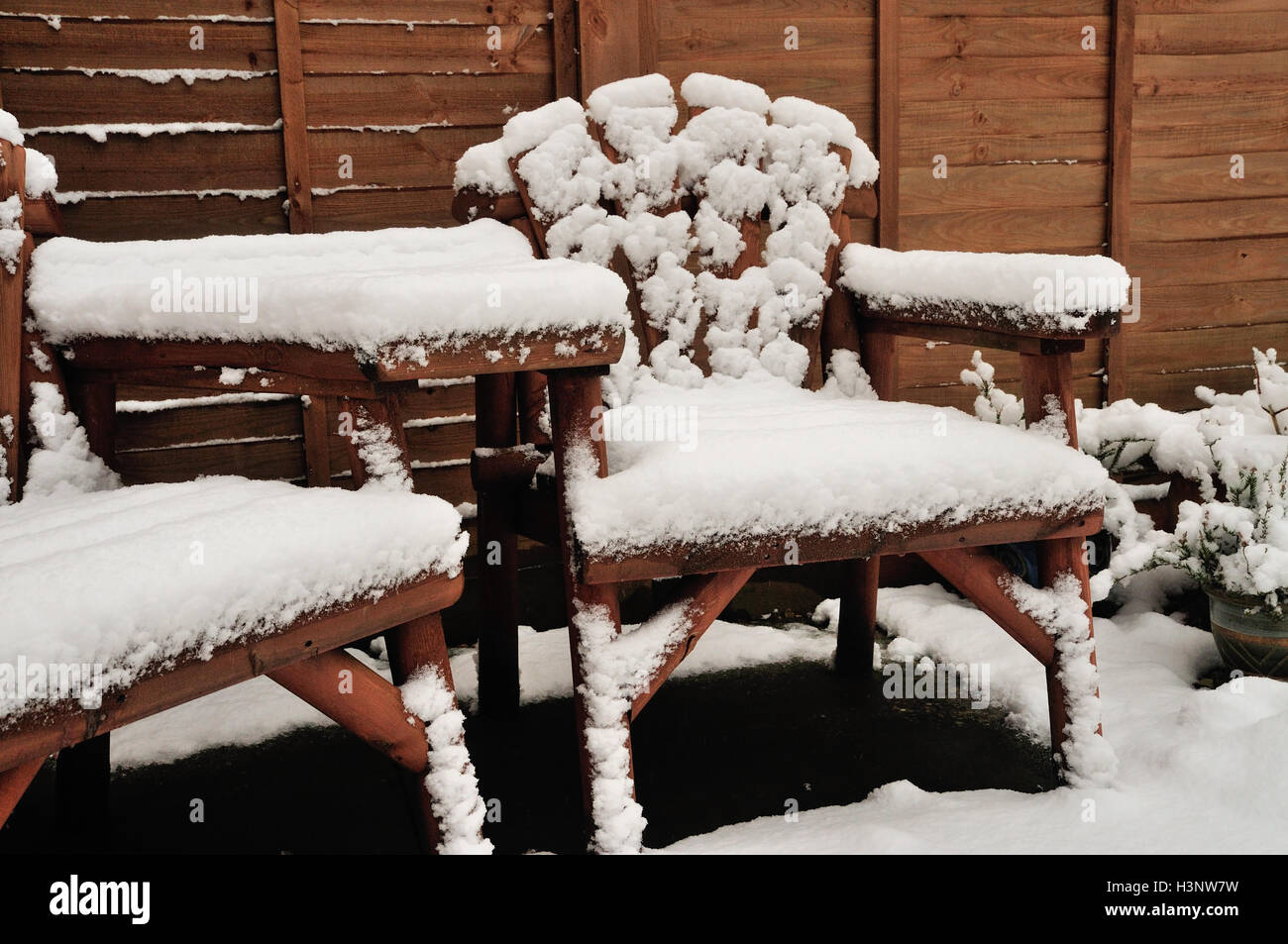 Snow covered garden seats Stock Photo - Alamy