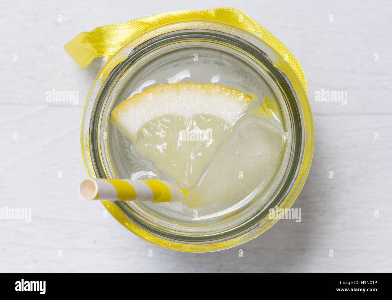 Lemon lemonade with ice and drinking straw Stock Photo - Alamy
