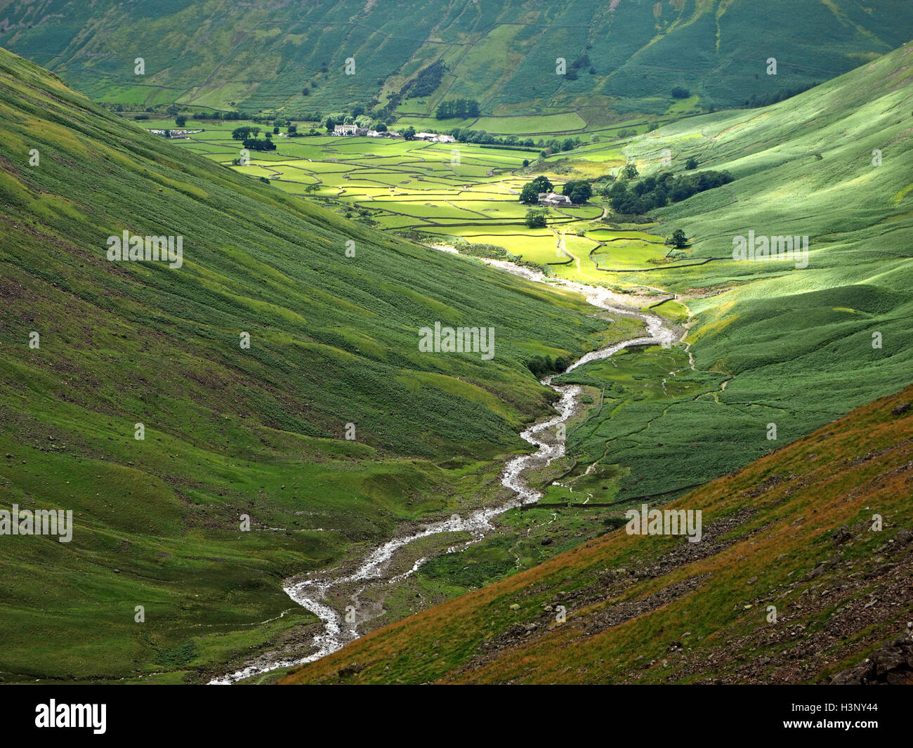 view of the hamlet of Wasdale Head in sunshine from flanks of Great ...