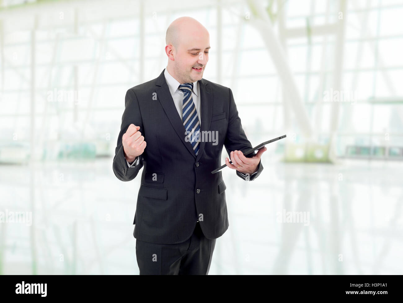 businessman winning, using touch pad of tablet pc, at the office Stock ...
