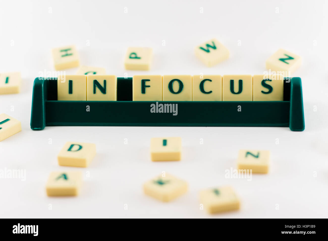 Letters forming the words IN FOCUS put in a container Stock Photo - Alamy