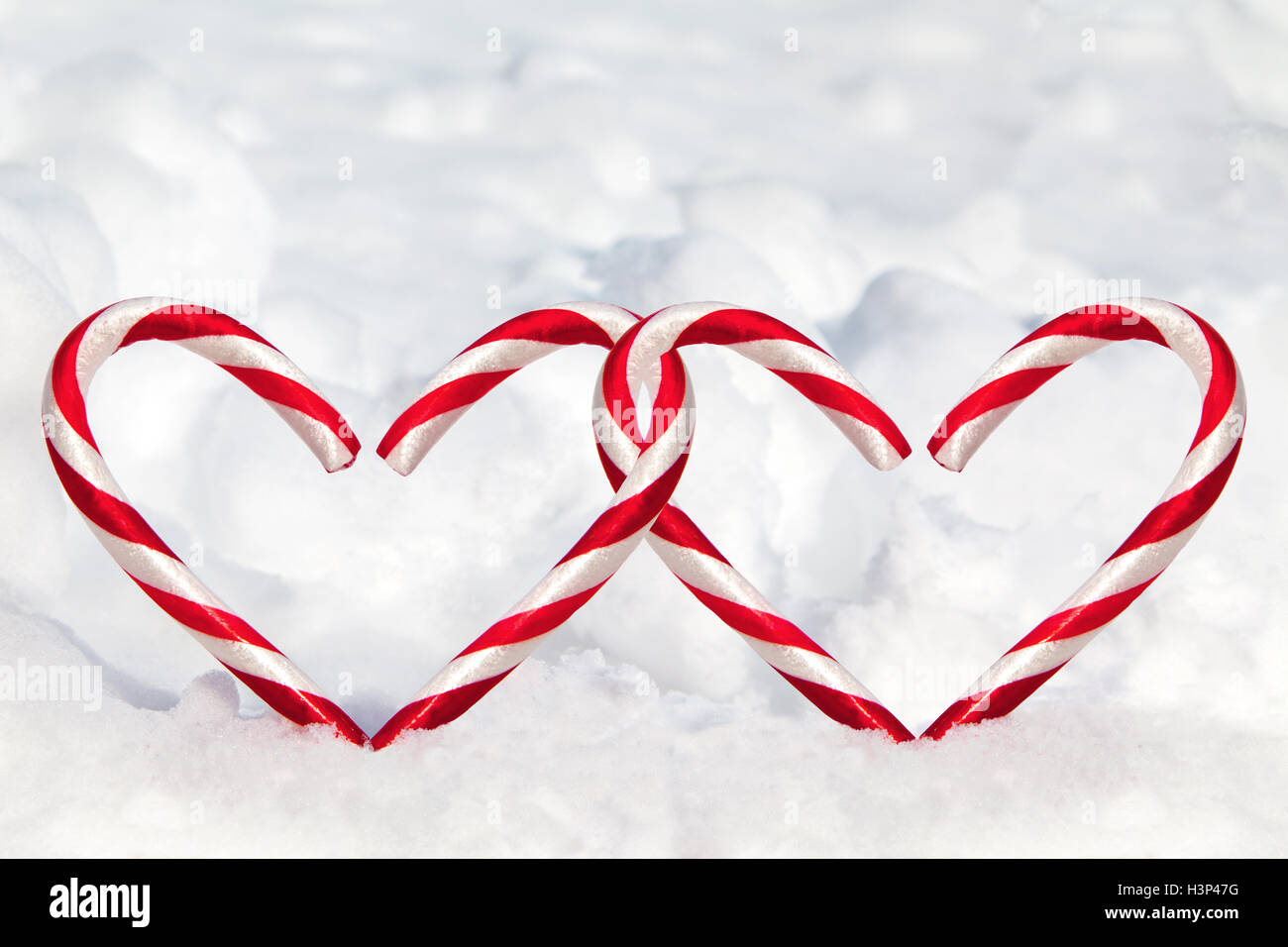 Dual heart-shaped candy canes in the snow with copy space Stock Photo - Alamy