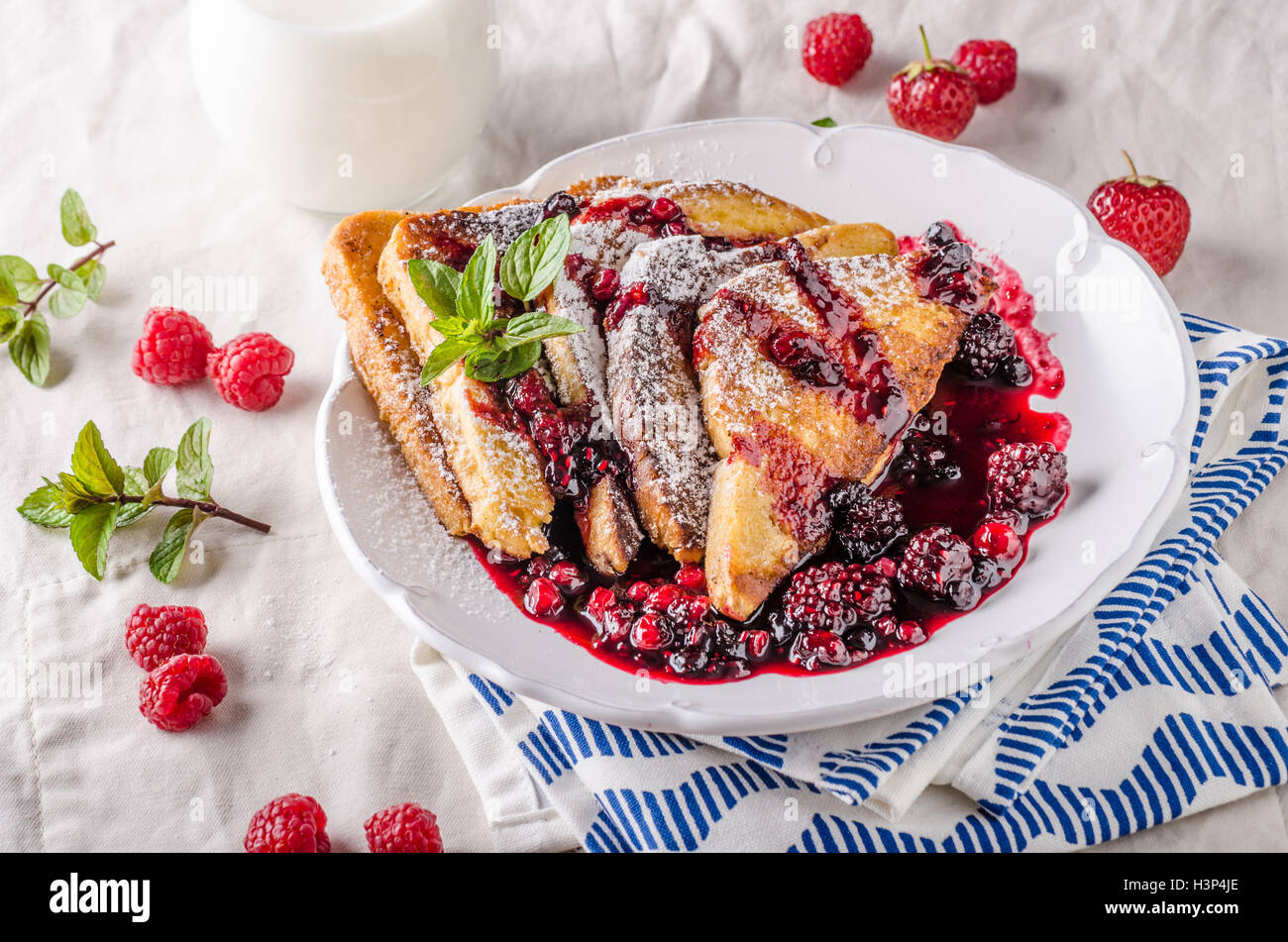 French toast with fruits and forest fruit reduction Stock Photo - Alamy