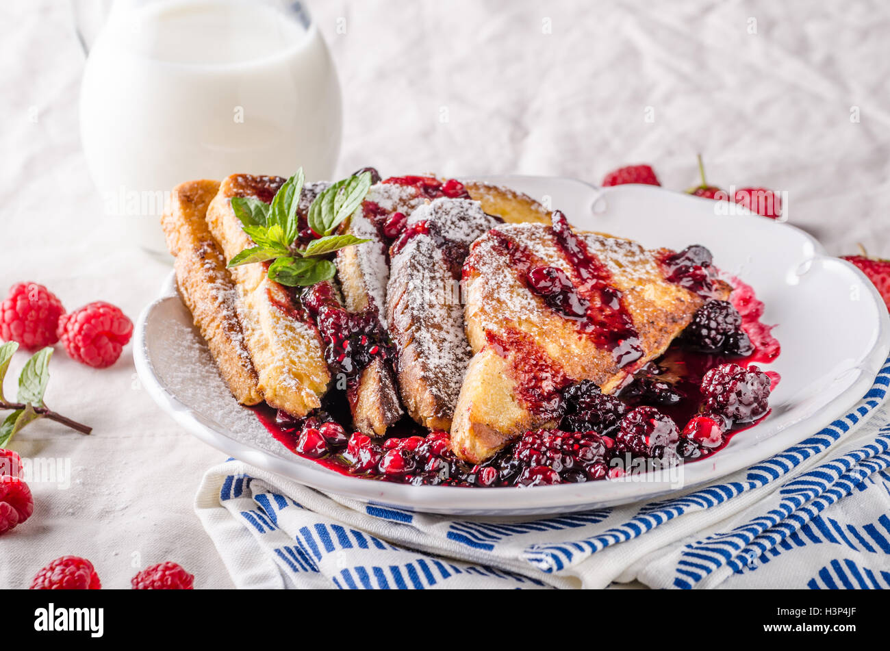 French toast with fruits and forest fruit reduction Stock Photo - Alamy