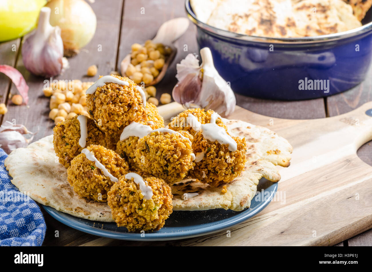 Falafel fried on naan bread, with garlic sauce Stock Photo - Alamy