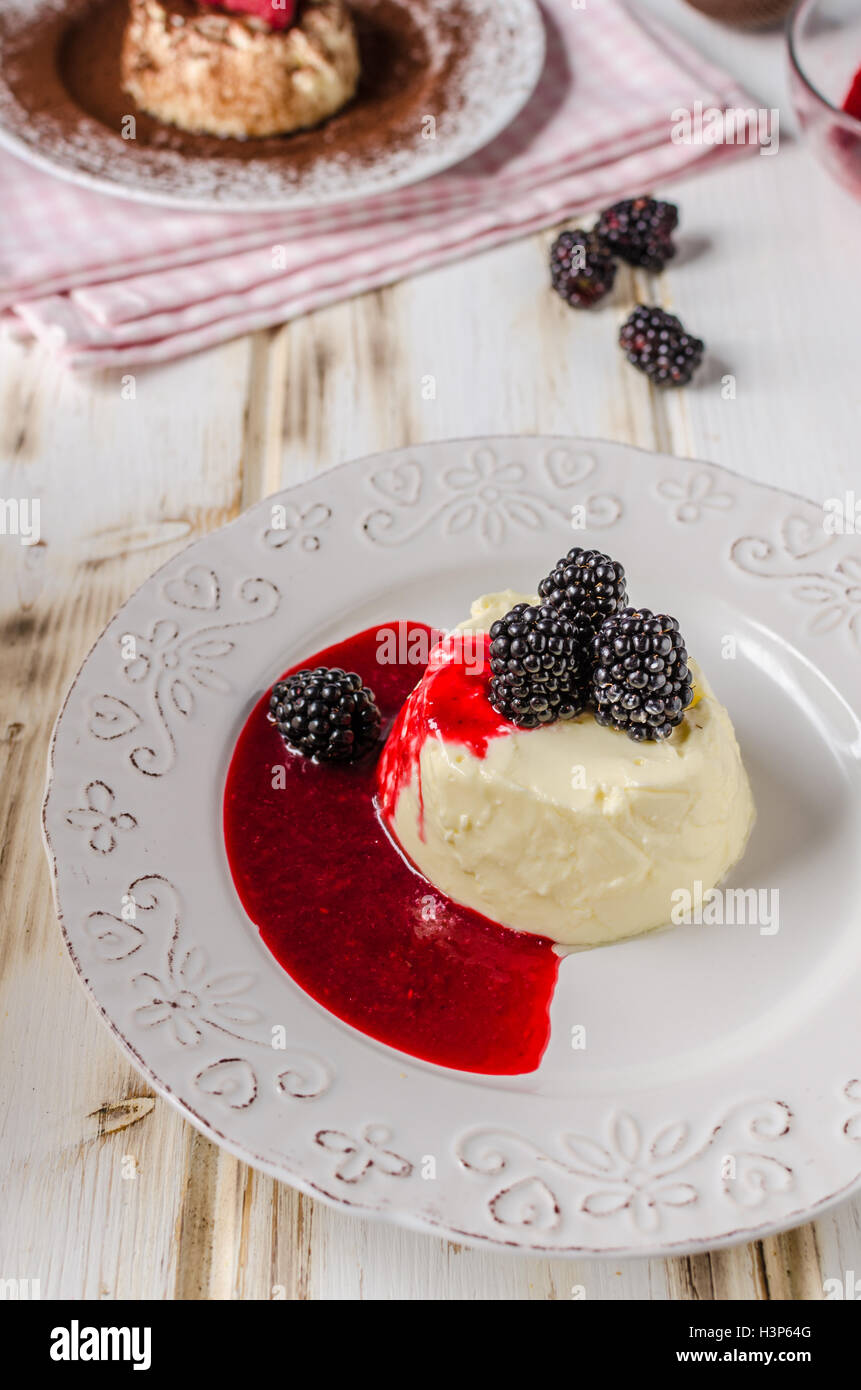 Vanilla panna cotta with wild berry sauce Stock Photo - Alamy