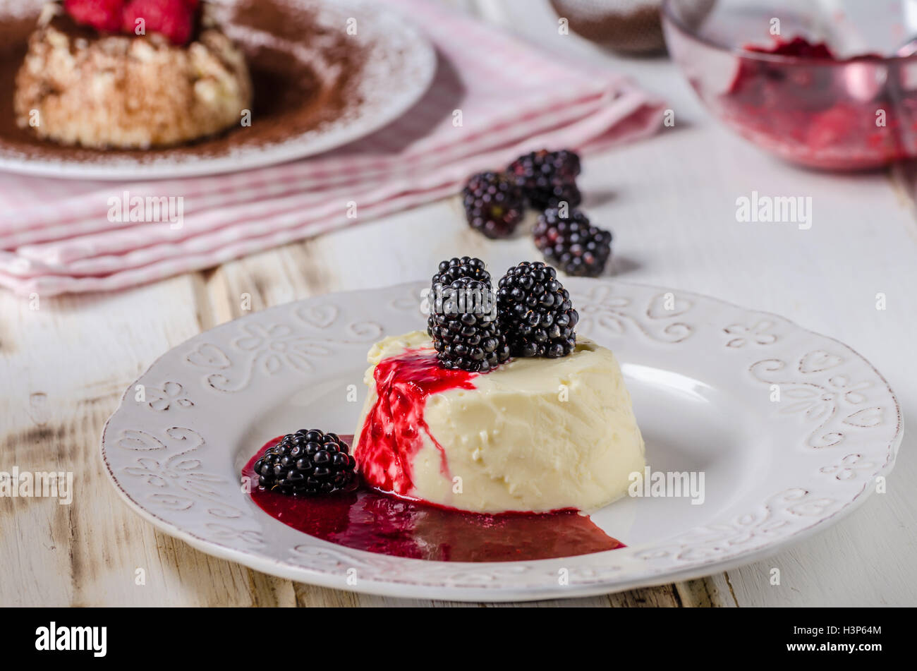 Vanilla panna cotta with wild berry sauce Stock Photo - Alamy