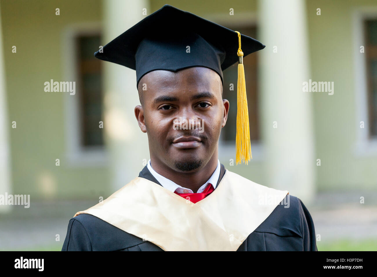 Graduate students wearing graduation hat and gown Stock Photo - Alamy