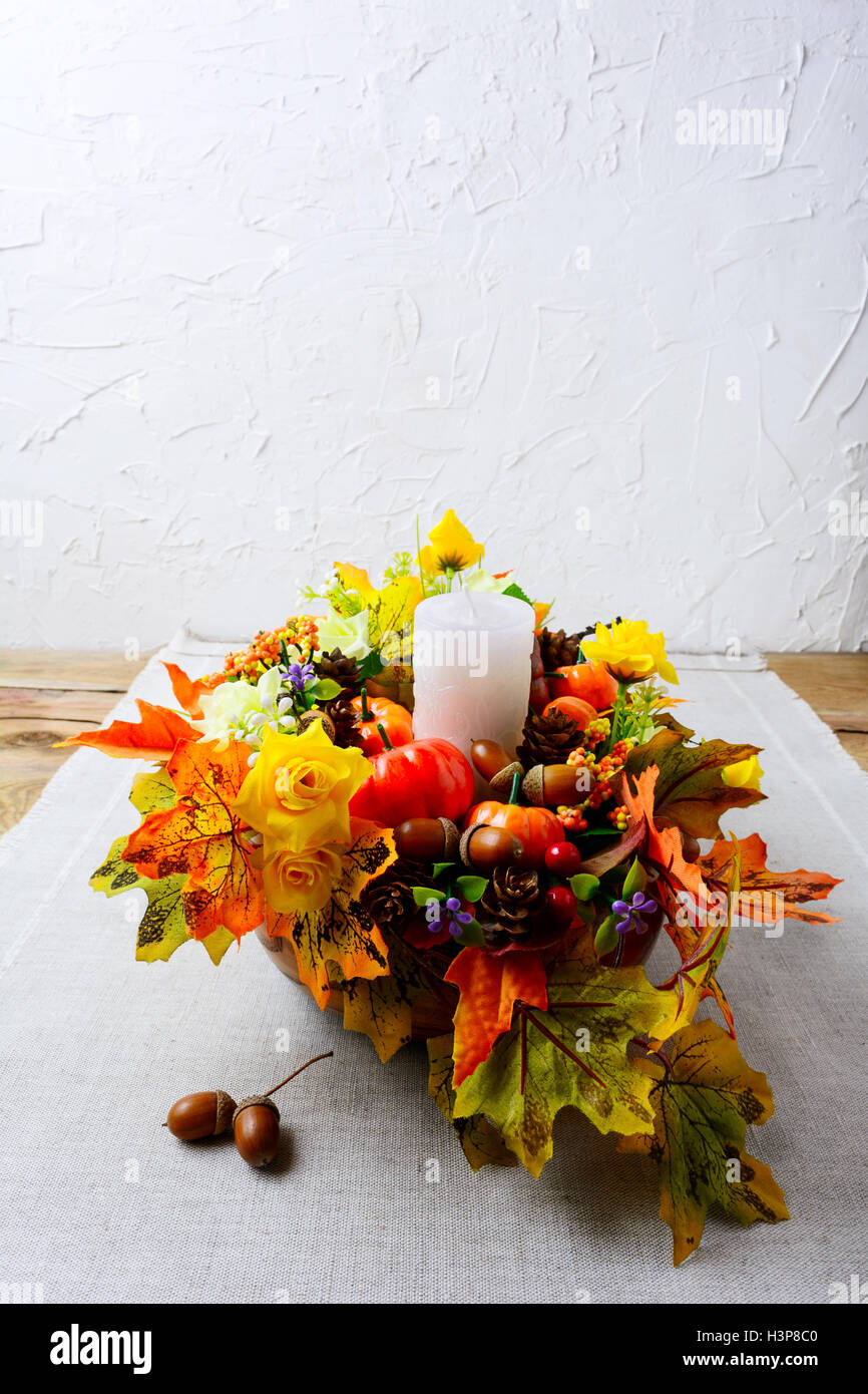 Thanksgiving decoration with silk fall leaves on linen napkin, vertical ...
