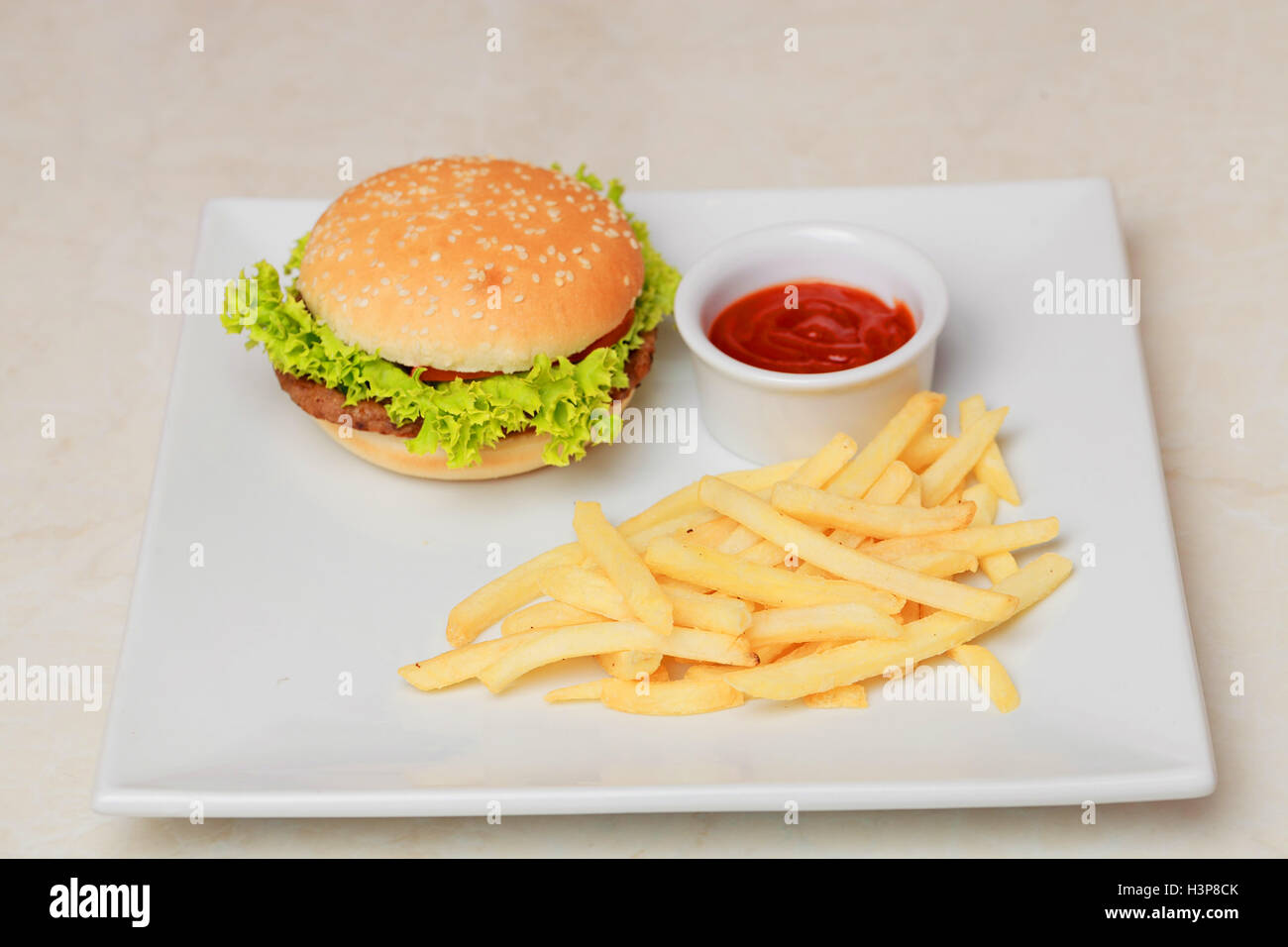 classic burger with French fries on the table Stock Photo - Alamy