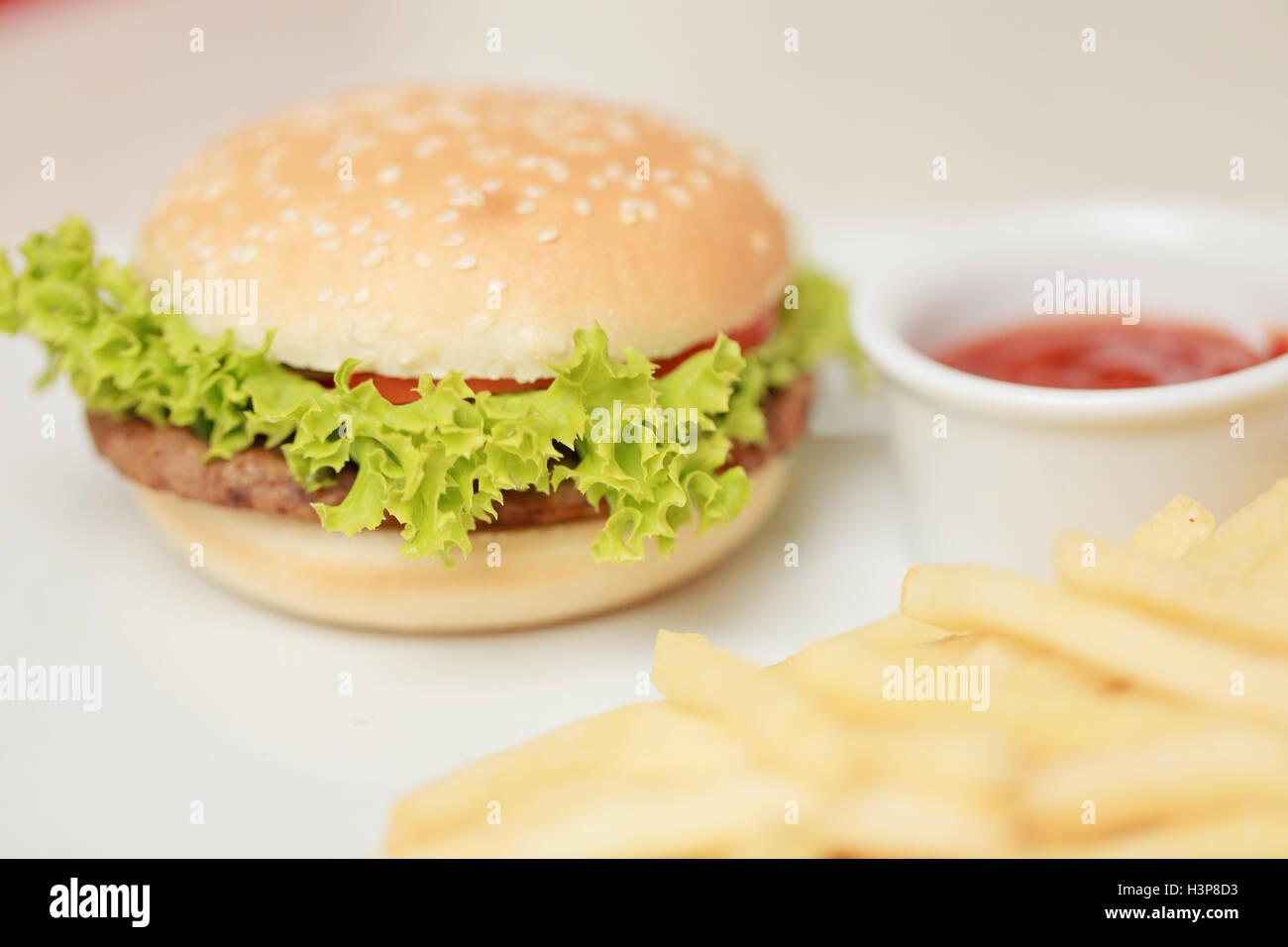 classic burger with French fries on the table Stock Photo - Alamy