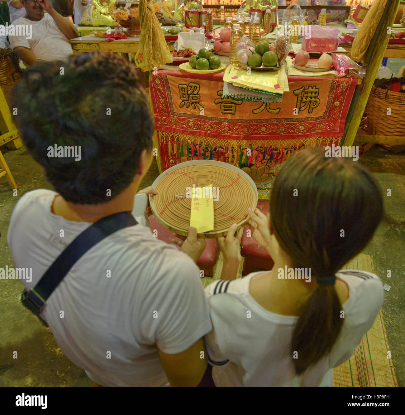 praying for good luck at the Vegetarian Festival in Bangkok, Thailand ...