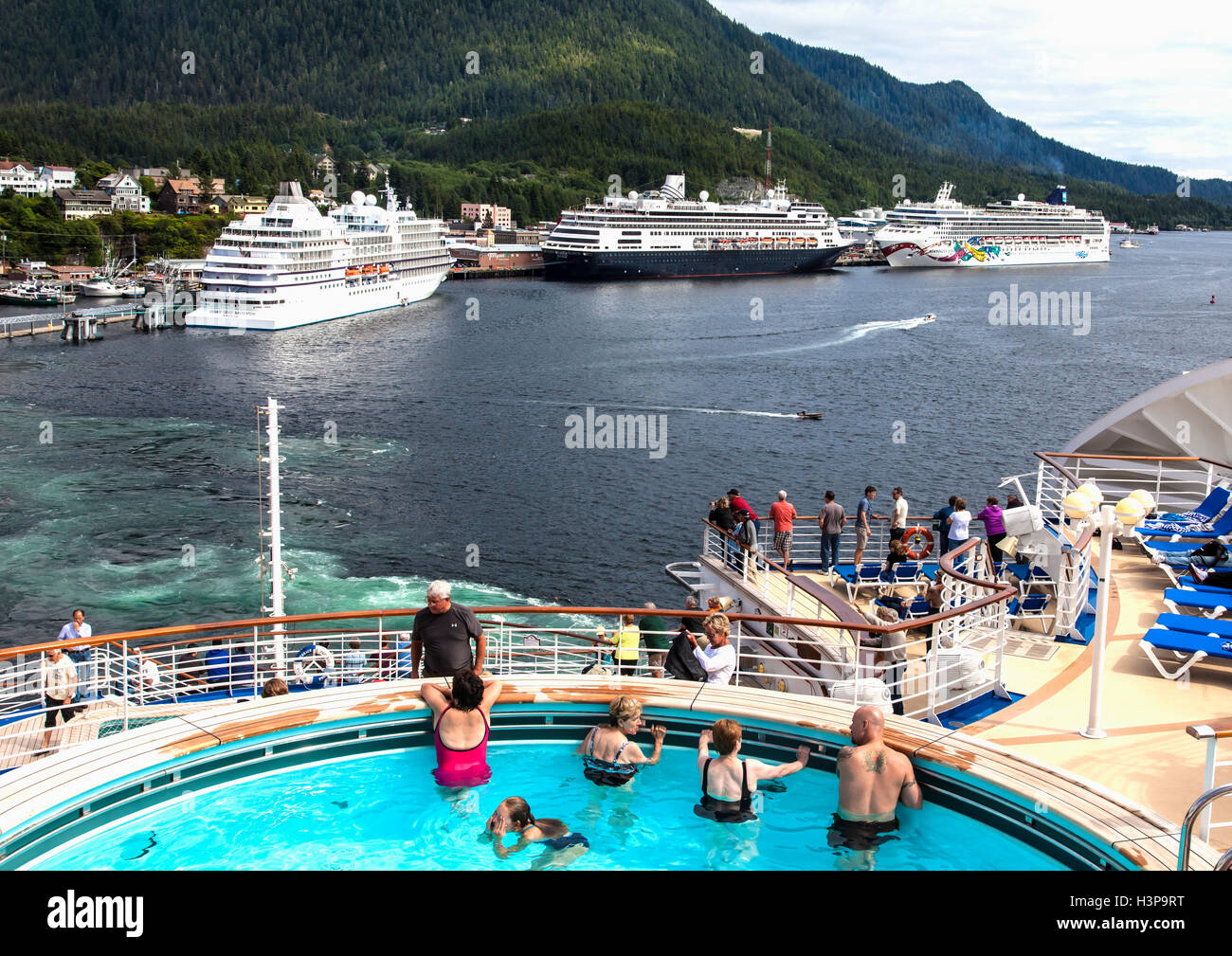 Passengers swim while their cruise ship departs Ketchikan in Alaska ...