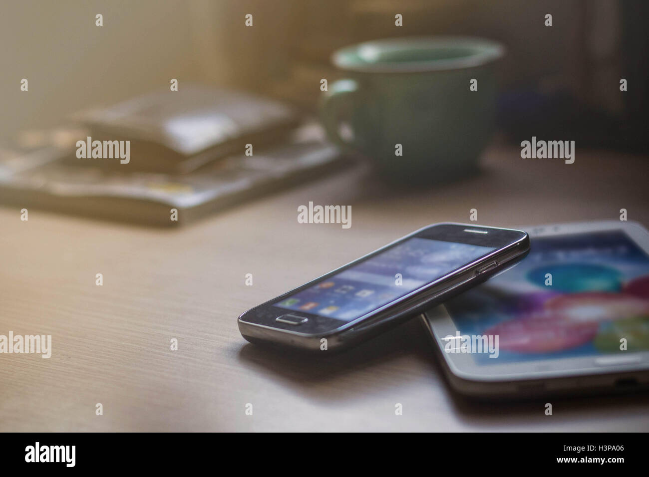 Mobile phones and tablets on the desk Stock Photo - Alamy
