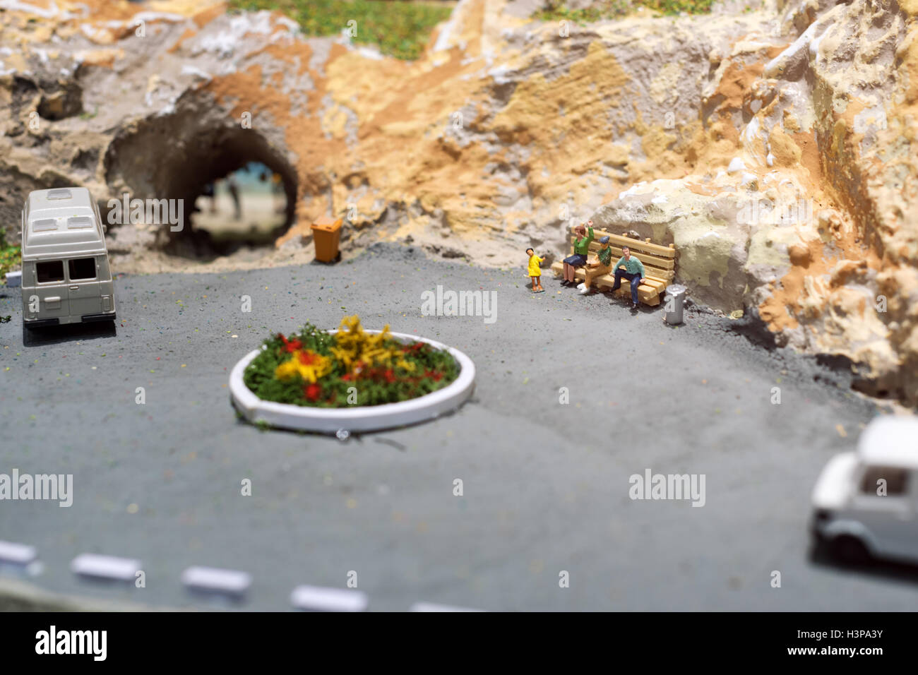 Miniature world: people waiting for their transport on the bus stop ...