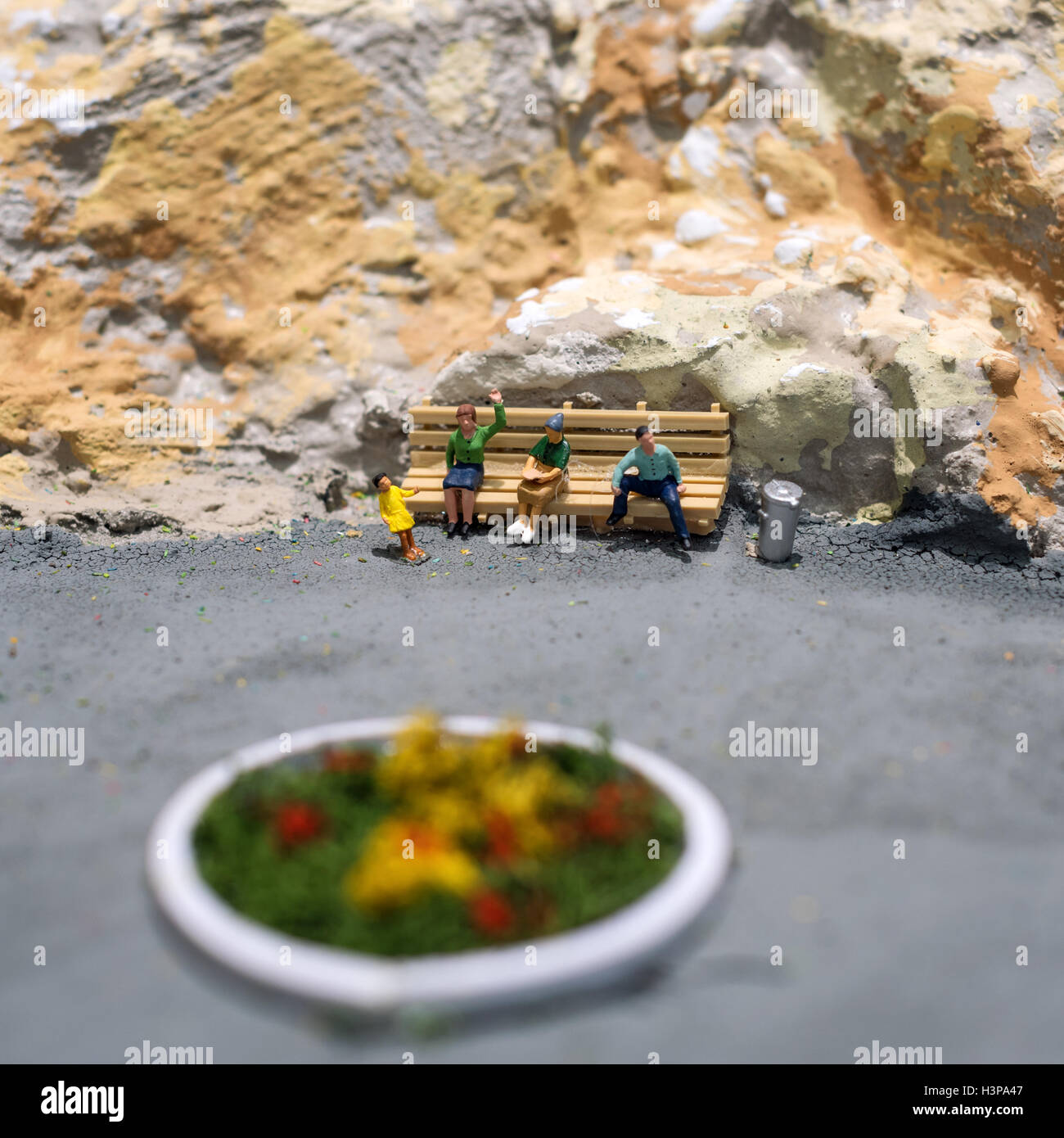 Miniature world: people waiting for their transport on the bus stop ...