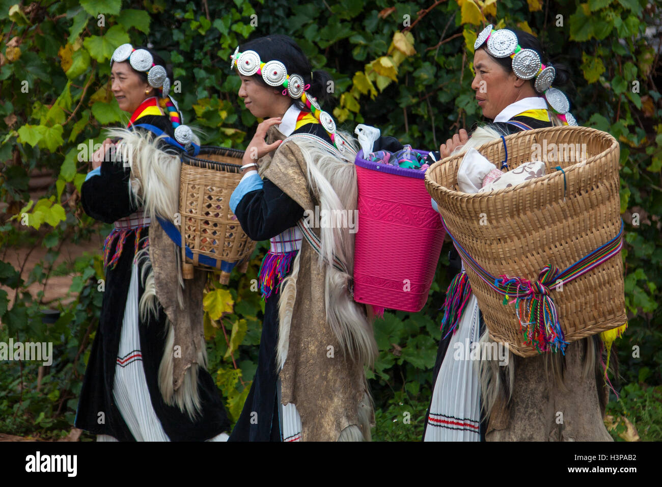 Naxi people in folk costumes showing everyday life Yunnan, China Stock ...