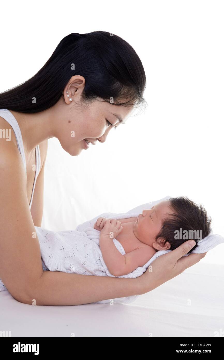 MODEL RELEASED. Mother cradling newborn baby girl Stock Photo - Alamy