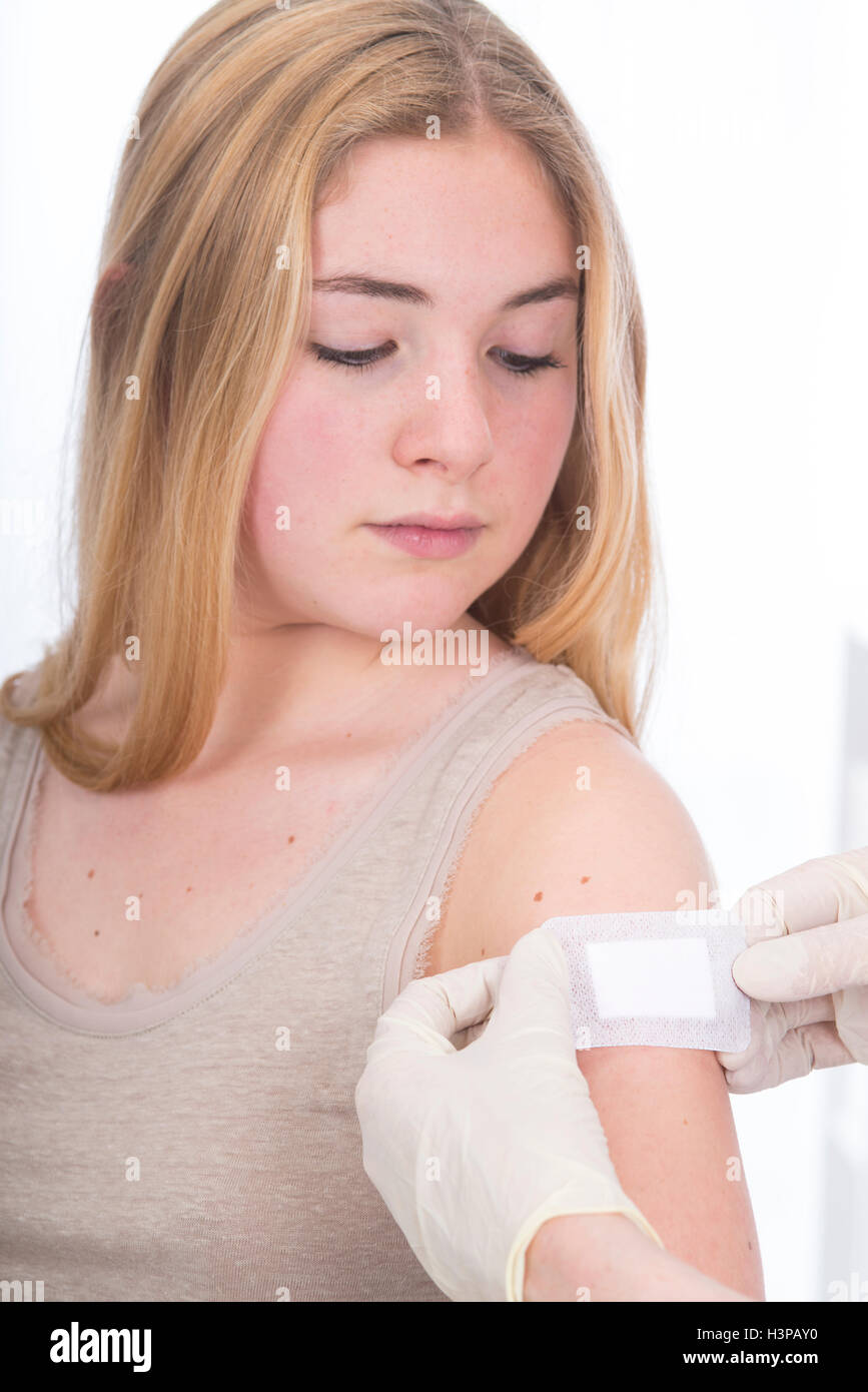 MODEL RELEASED. Teenage girl with plaster on arm Stock Photo - Alamy