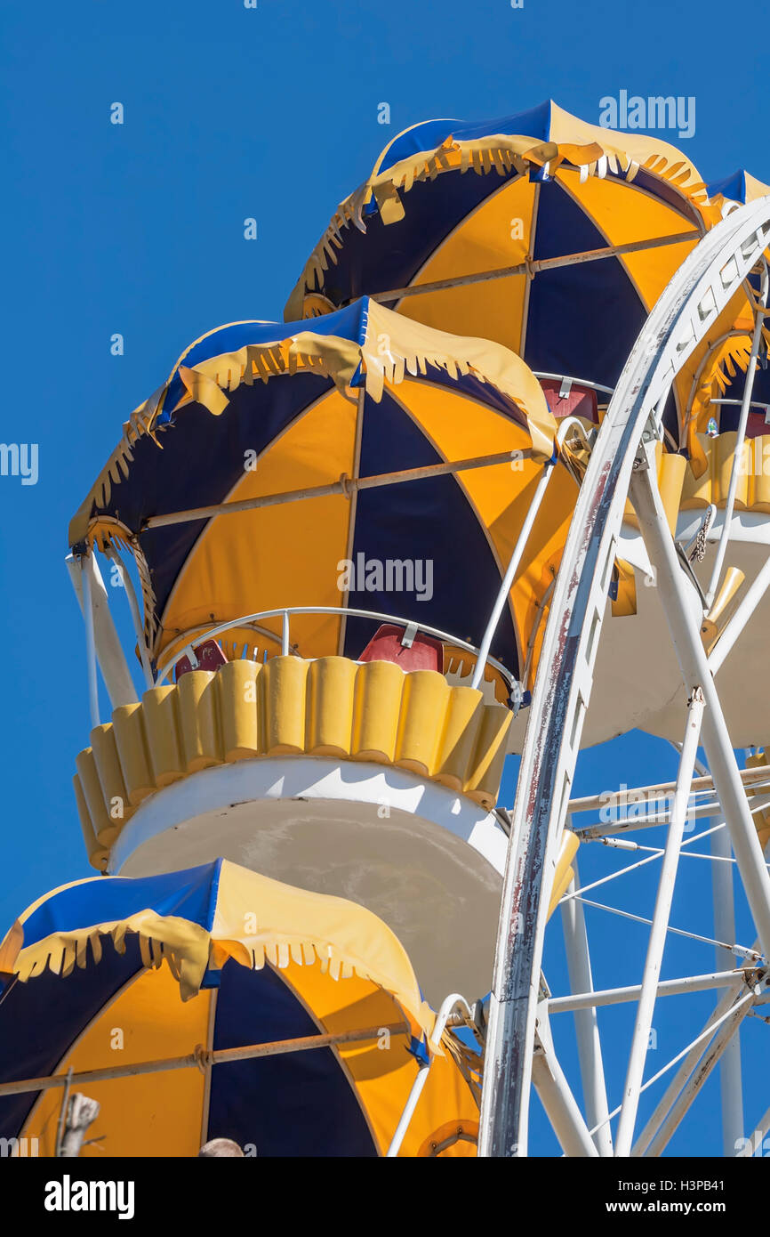 Cabs Ferris wheel yellow-blue color on a background of blue sky Stock ...