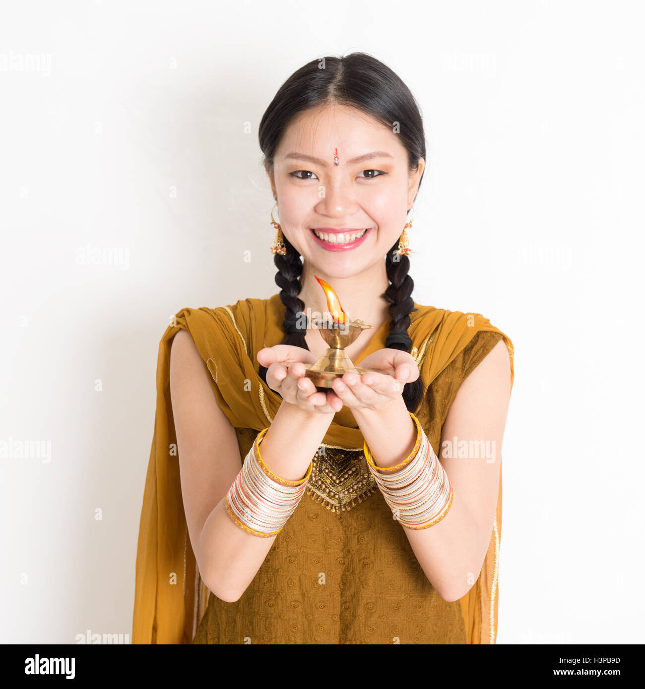 Mixed race Indian Chinese female in traditional dress hands holding ...