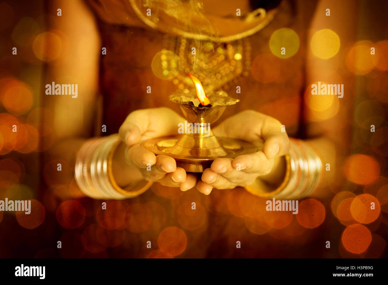 Woman holding diya hi-res stock photography and images - Alamy