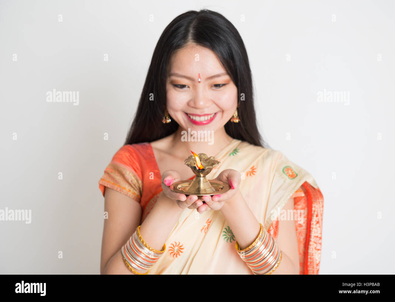 Portrait of young mixed race Indian Chinese girl in traditional sari ...
