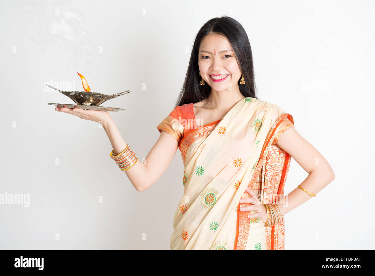 Portrait of young mixed race Indian Chinese female in traditional sari ...