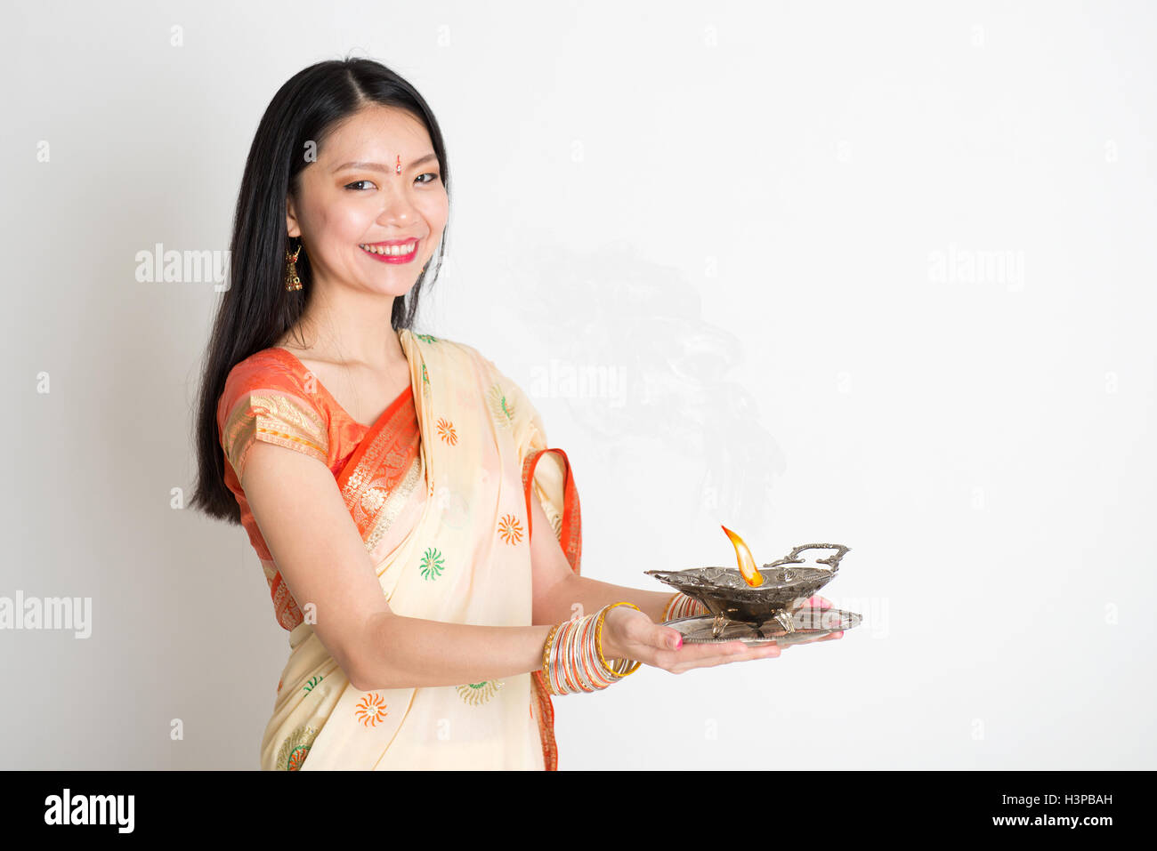 Portrait of young mixed race Indian Chinese female in traditional sari ...