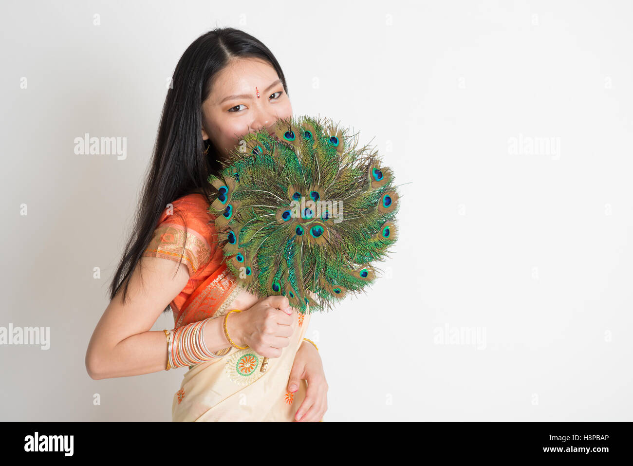Portrait of young mixed race Indian Chinese female in traditional sari ...