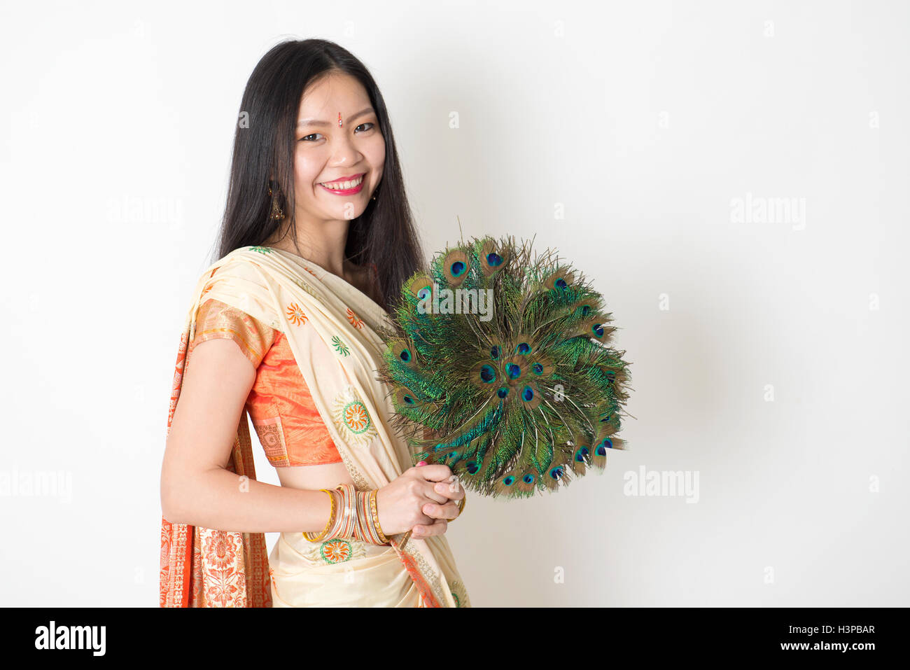 Portrait of young mixed race Indian Chinese girl in traditional sari ...