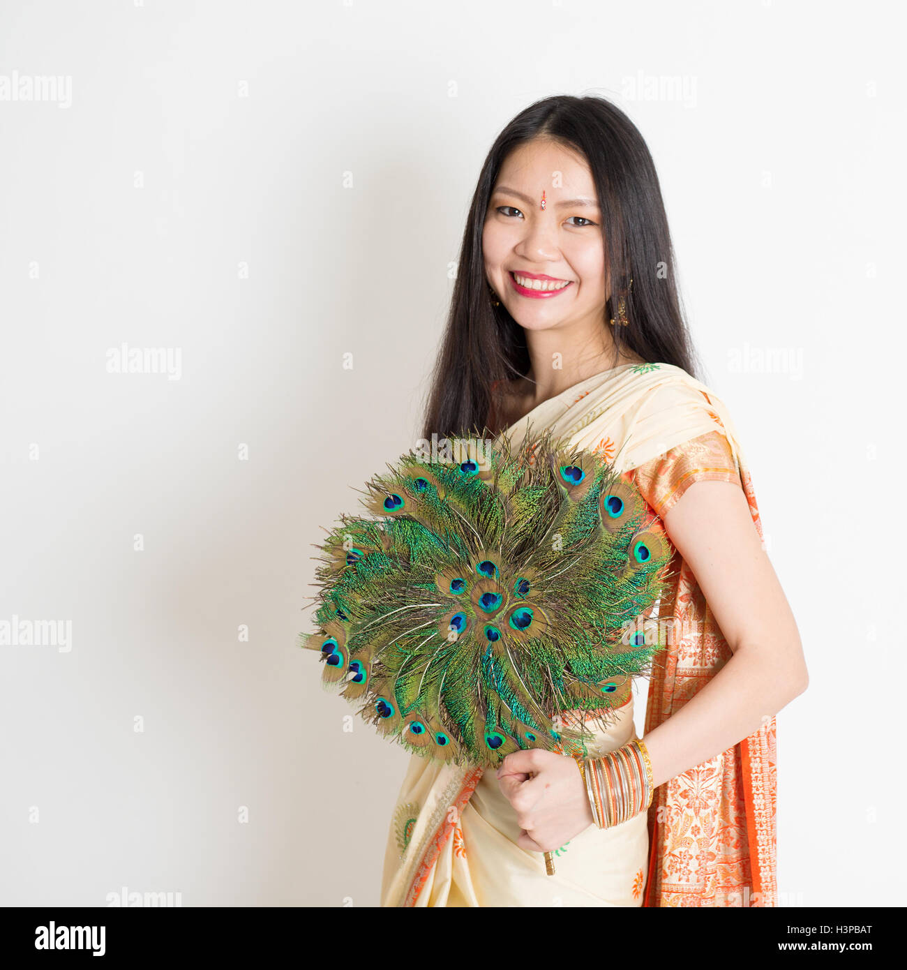 Portrait of young mixed race Indian Chinese female in traditional sari ...