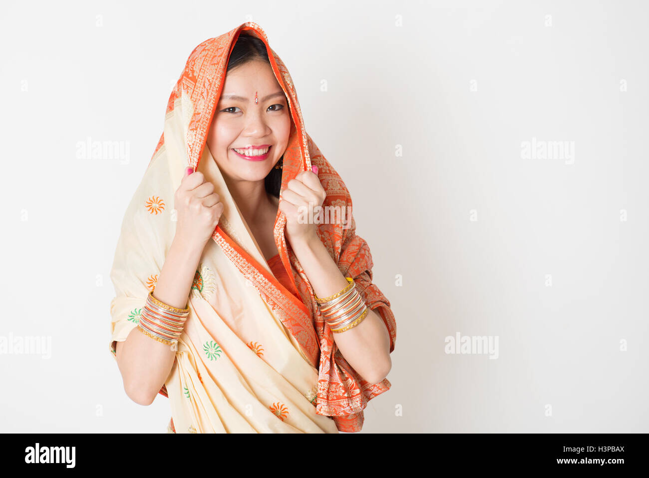 Portrait of young mixed race Indian Chinese woman in traditional sari ...