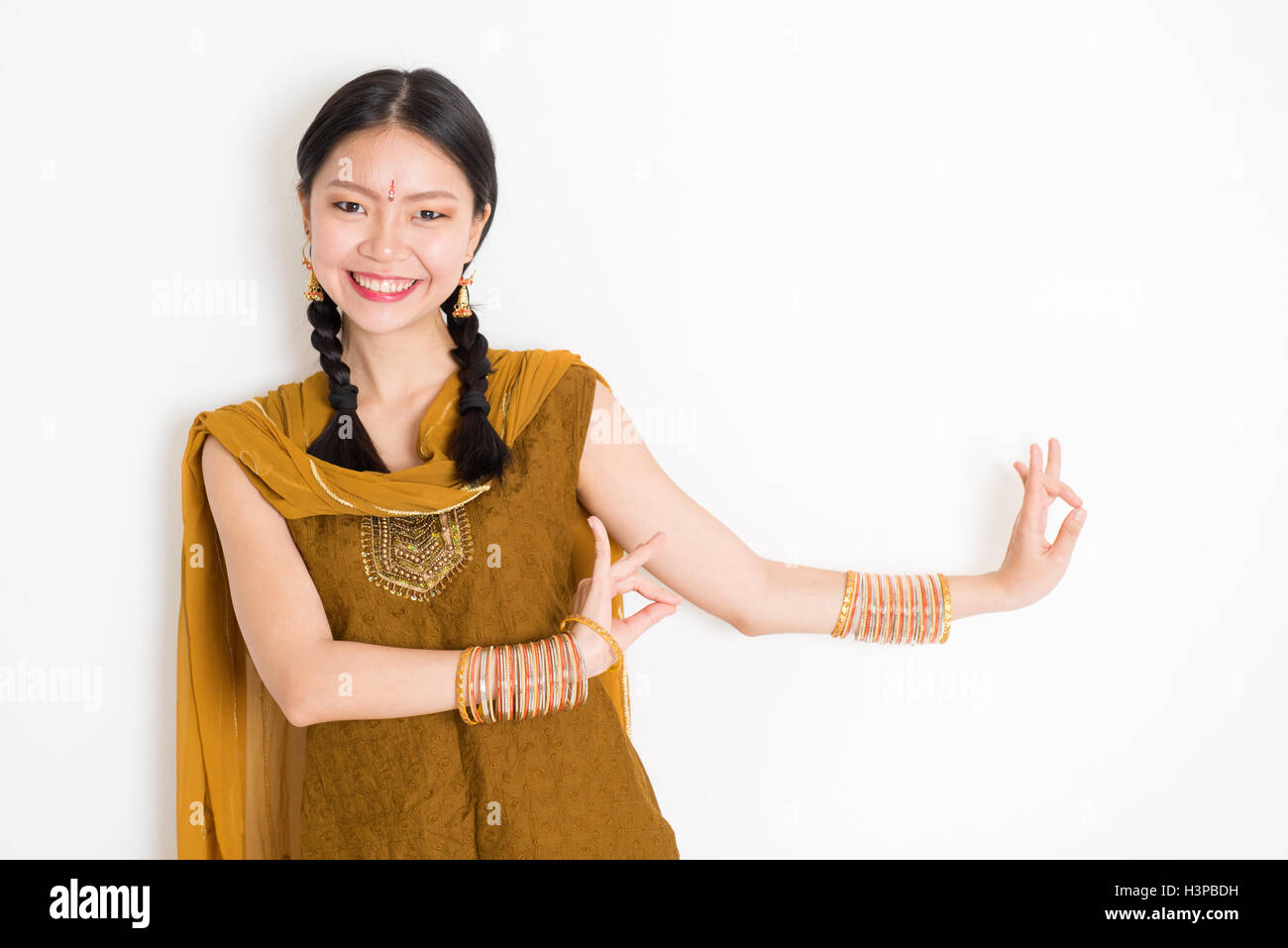Portrait of young mixed race Indian Chinese girl dancer in traditional ...