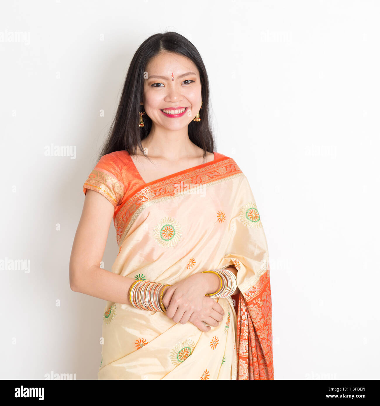 Portrait of young mixed race Indian Chinese woman with traditional sari ...