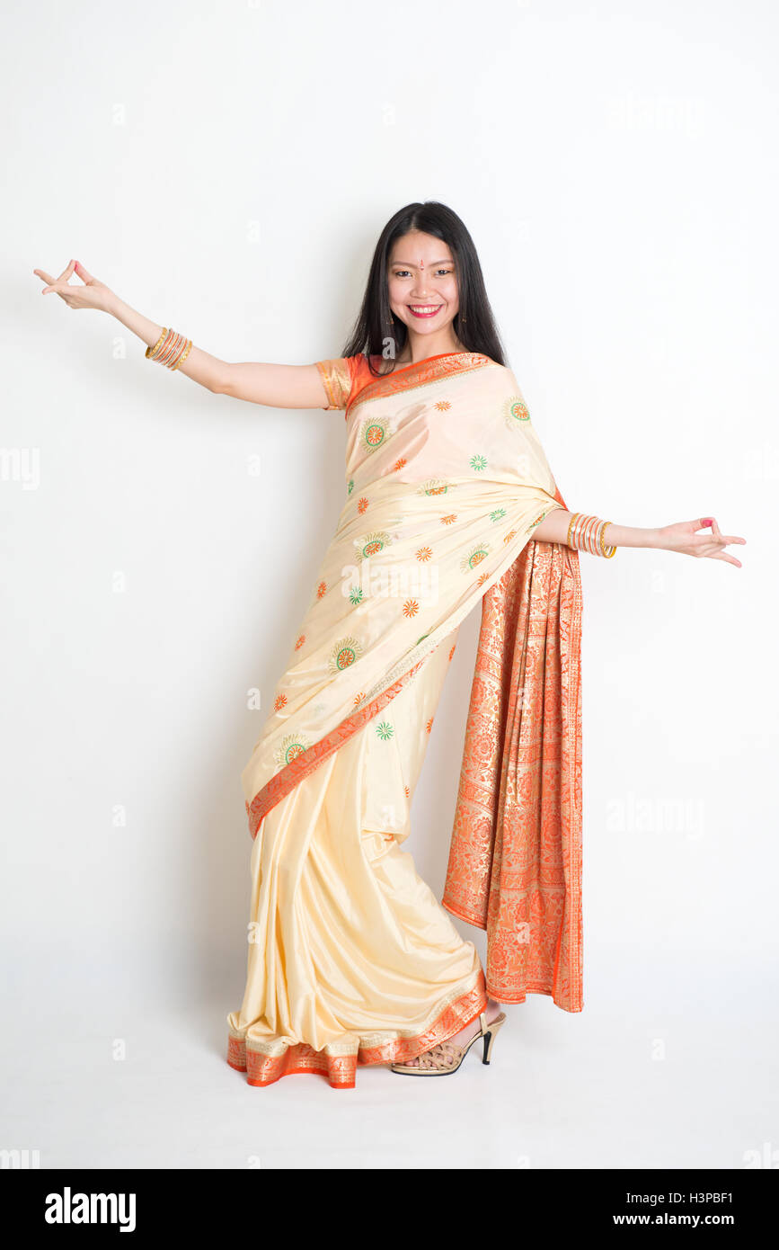 Full length portrait of young mixed race Indian Chinese woman in ...