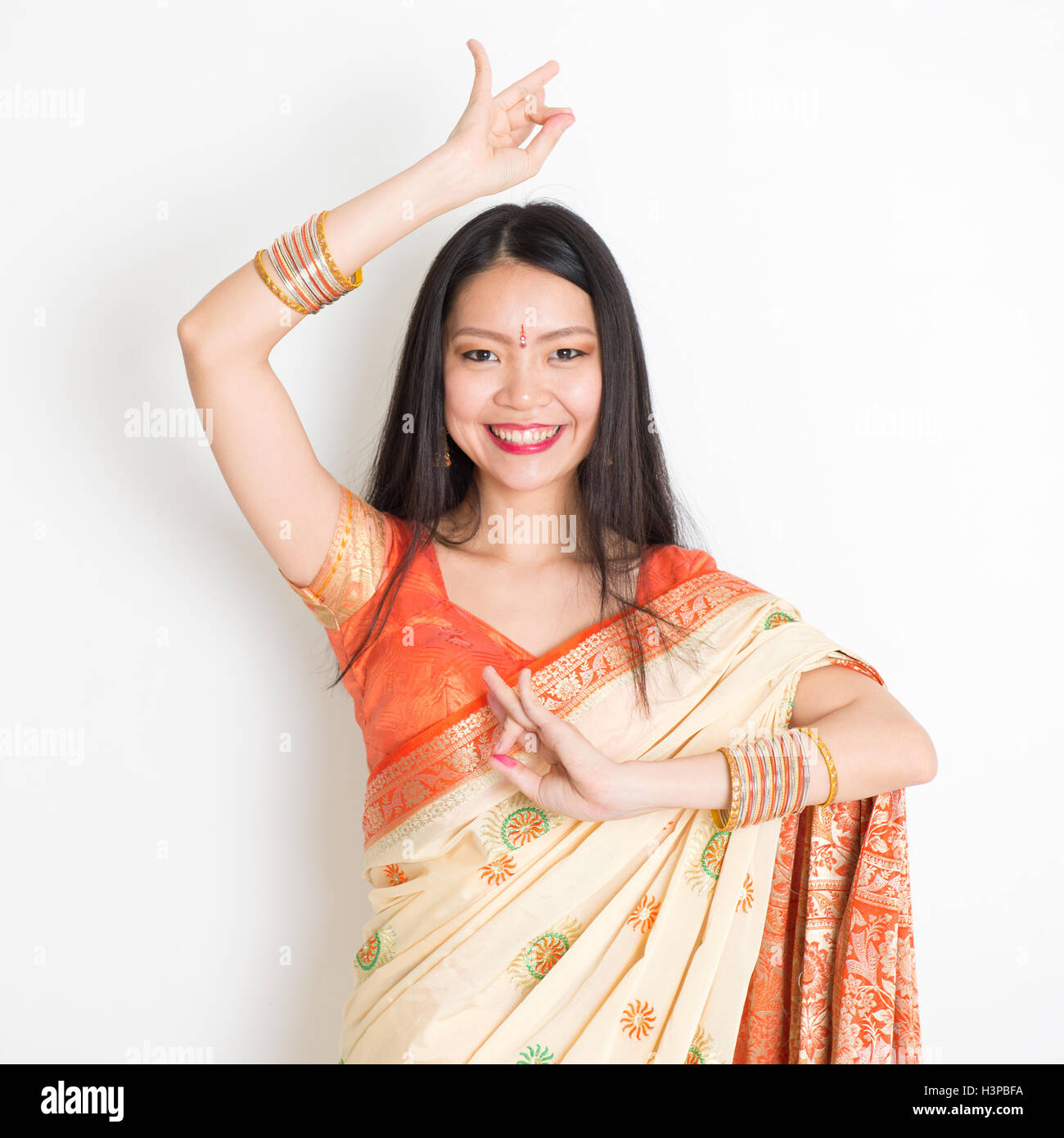 Portrait of young mixed race Indian Chinese woman in traditional sari ...