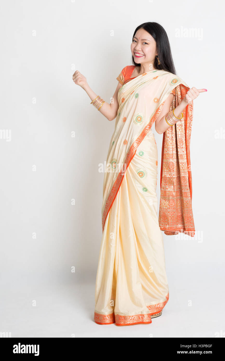 Portrait of young mixed race Indian Chinese woman in traditional sari ...
