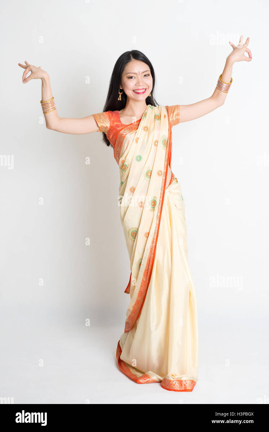 Portrait of young mixed race Indian Chinese female in traditional sari ...