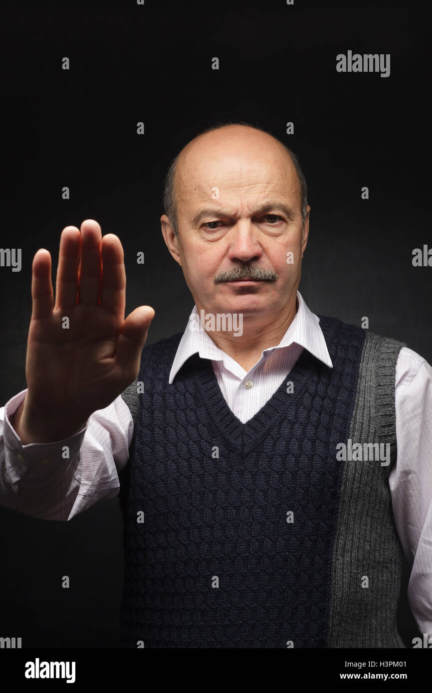 Strict man showing stop sign. Ban on the action Stock Photo - Alamy