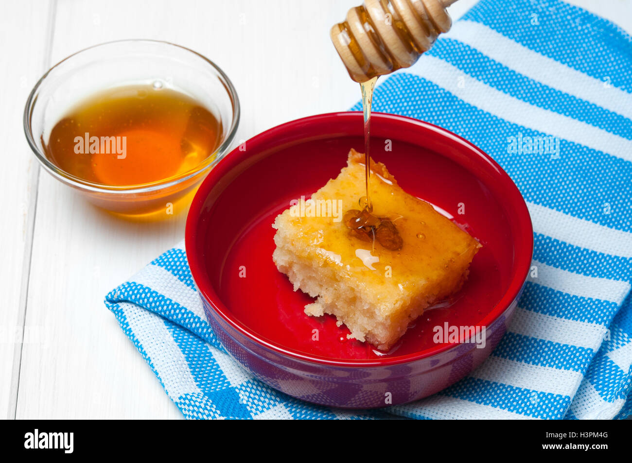 Basbousa - arabian cake with almonds and honey syrup in bowl on white ...