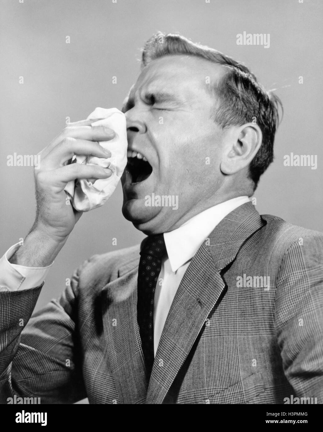Man sneezing 1950s Black and White Stock Photos & Images - Alamy