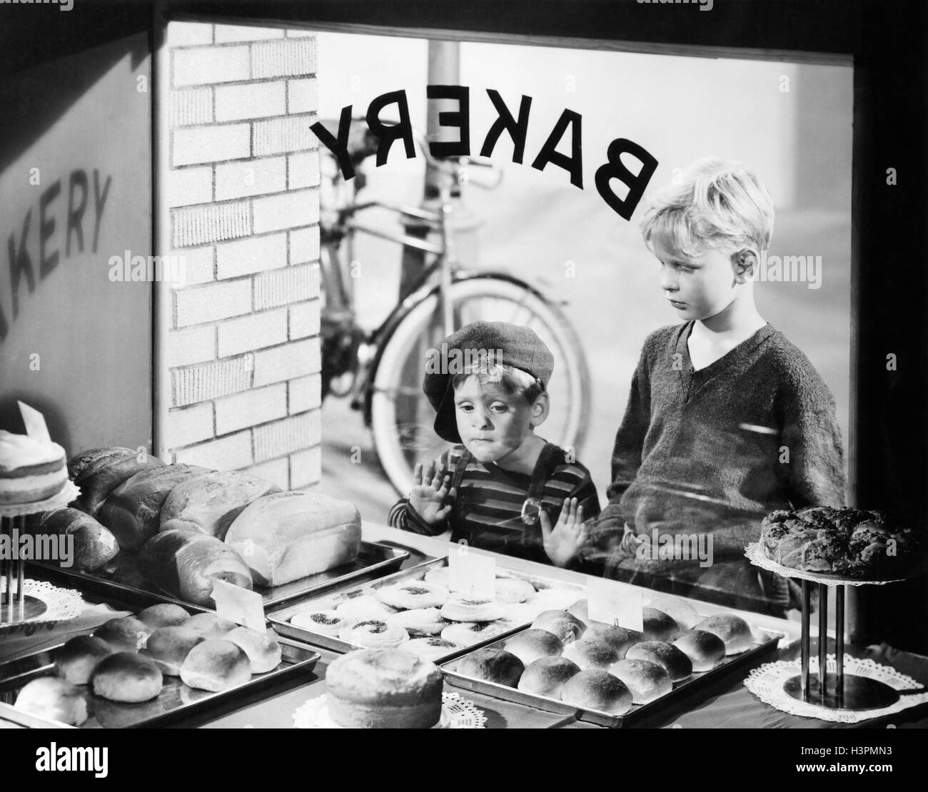 1930s 1940s TWO BOYS LOOKING IN BAKERY SHOP WINDOW AT DESSERTS ONE ...