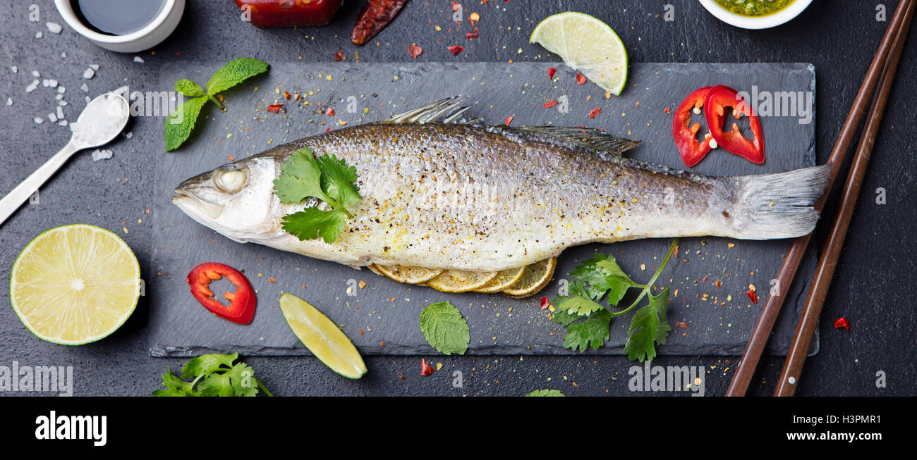 Roasted fish with sauces, fresh herbs and lime Stock Photo - Alamy