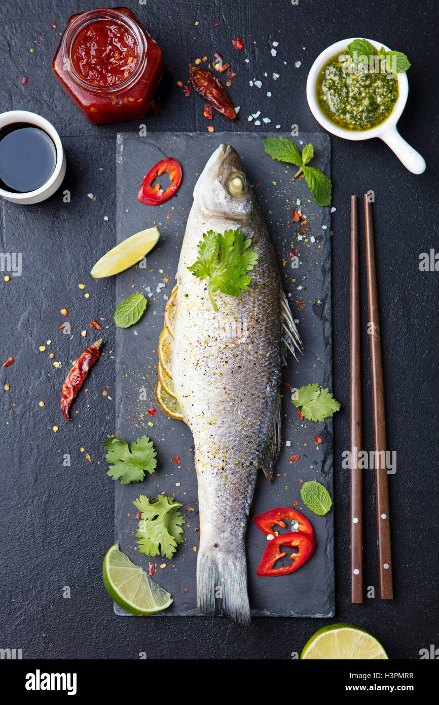 Roasted fish with sauces, fresh herbs and lime Stock Photo - Alamy
